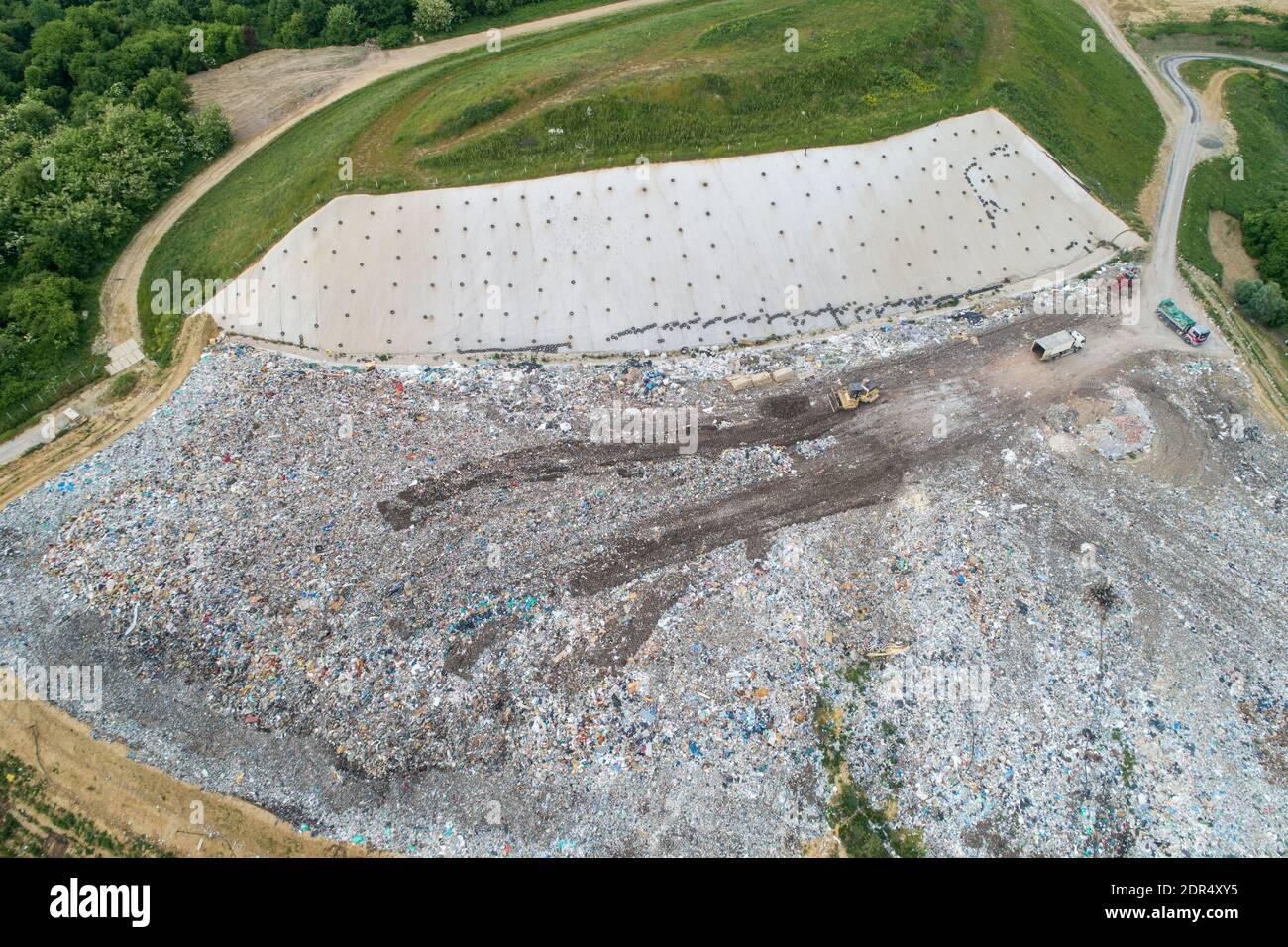 Garbage trucks unload garbage to a landfill, drone photo Stock Photo ...