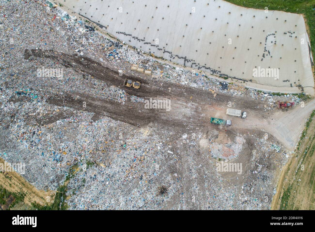 Garbage trucks unload garbage to a landfill, drone photo Stock Photo ...