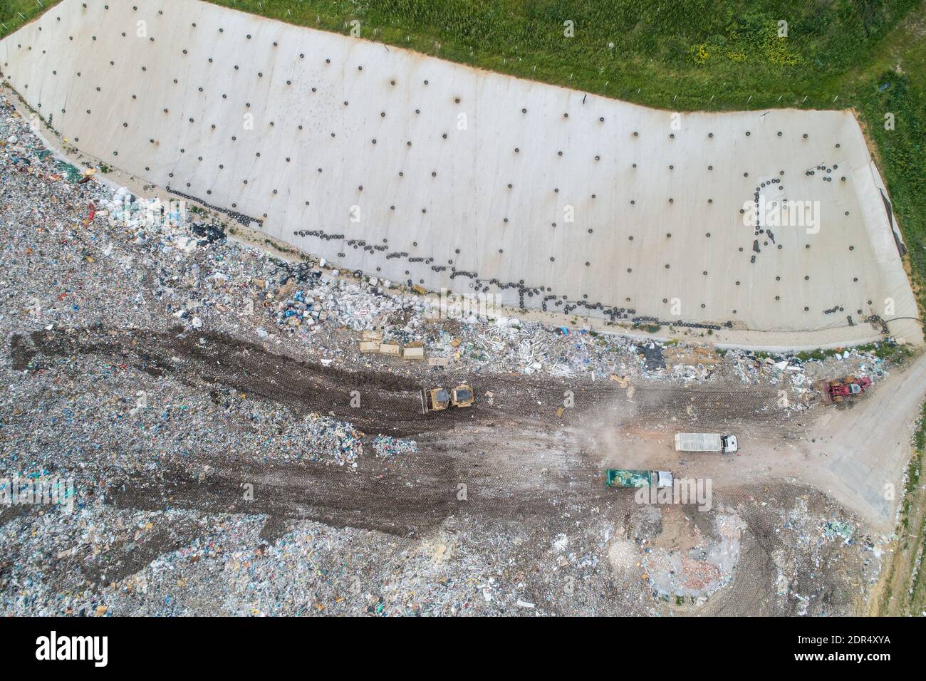 Garbage trucks unload garbage to a landfill, drone photo Stock Photo ...