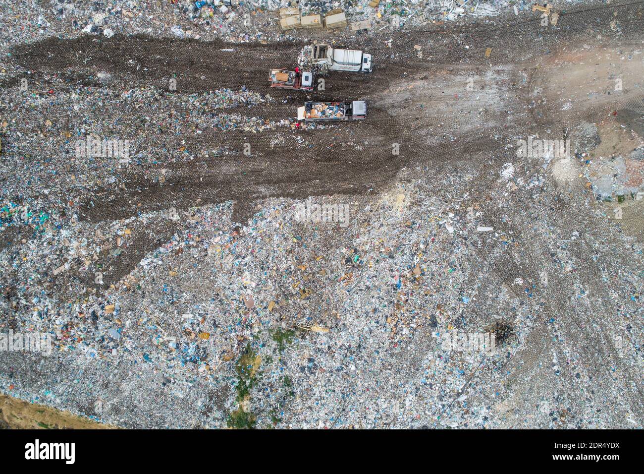 Garbage trucks unload garbage to a landfill, drone photo Stock Photo ...