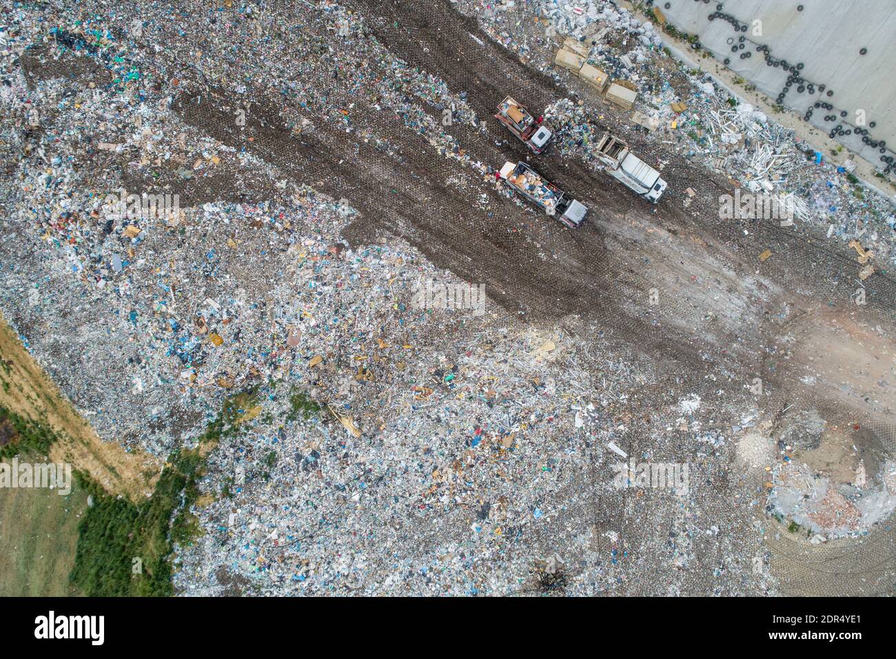Garbage trucks unload garbage to a landfill, drone photo Stock Photo ...