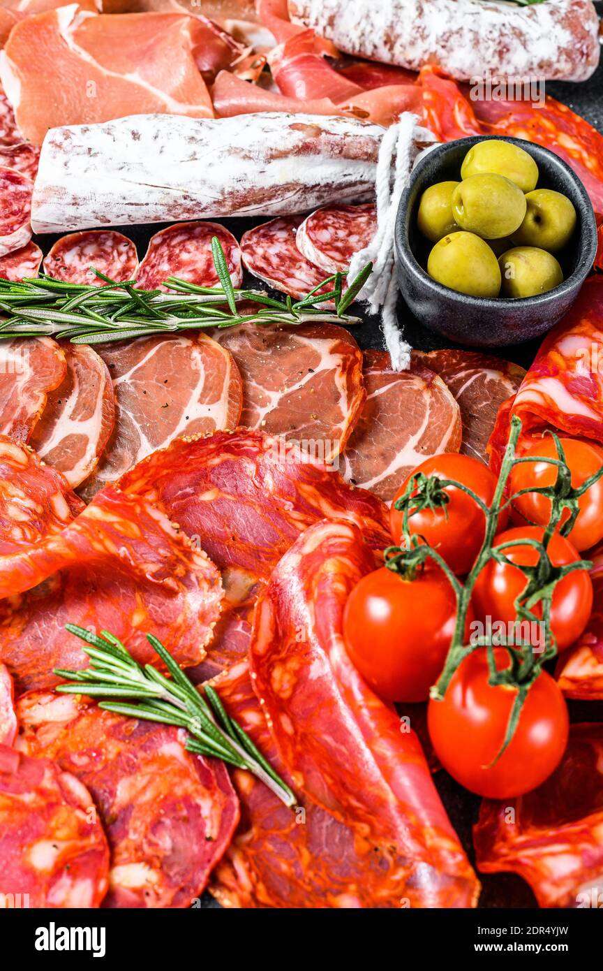 Cured meat platter of traditional Spanish tapas. Chorizo, jamon serrano ...