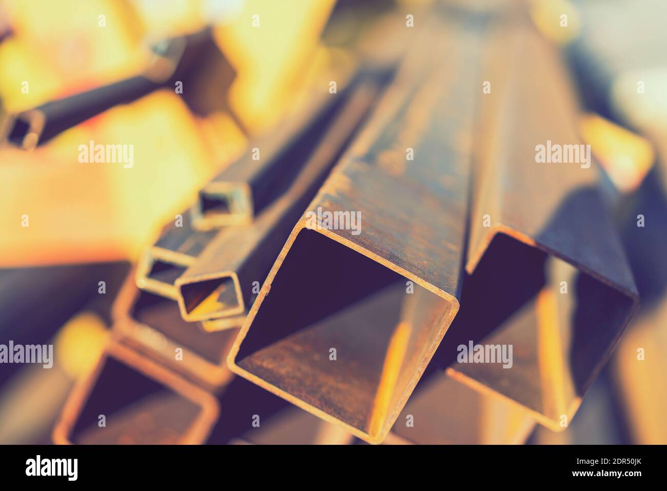 stack of steel pipe and metal beams on rack. metal pipes, profiles ...