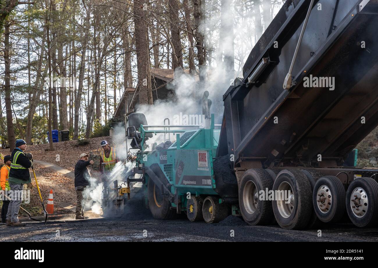 Steam billow from asphalt road paver on a winter day Stock Photo - Alamy