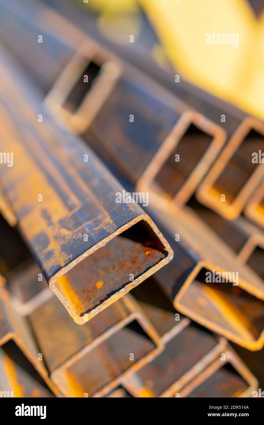 stack of steel pipe and metal beams on rack. metal pipes, profiles ...