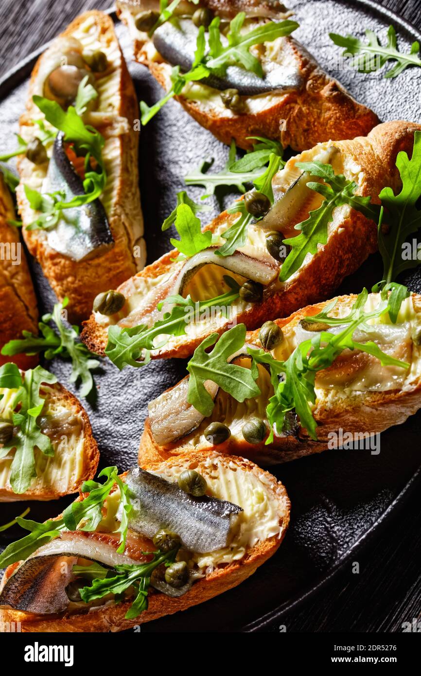 anchovy butter sandwiches with fresh rocket salad leaves, capers on a ...