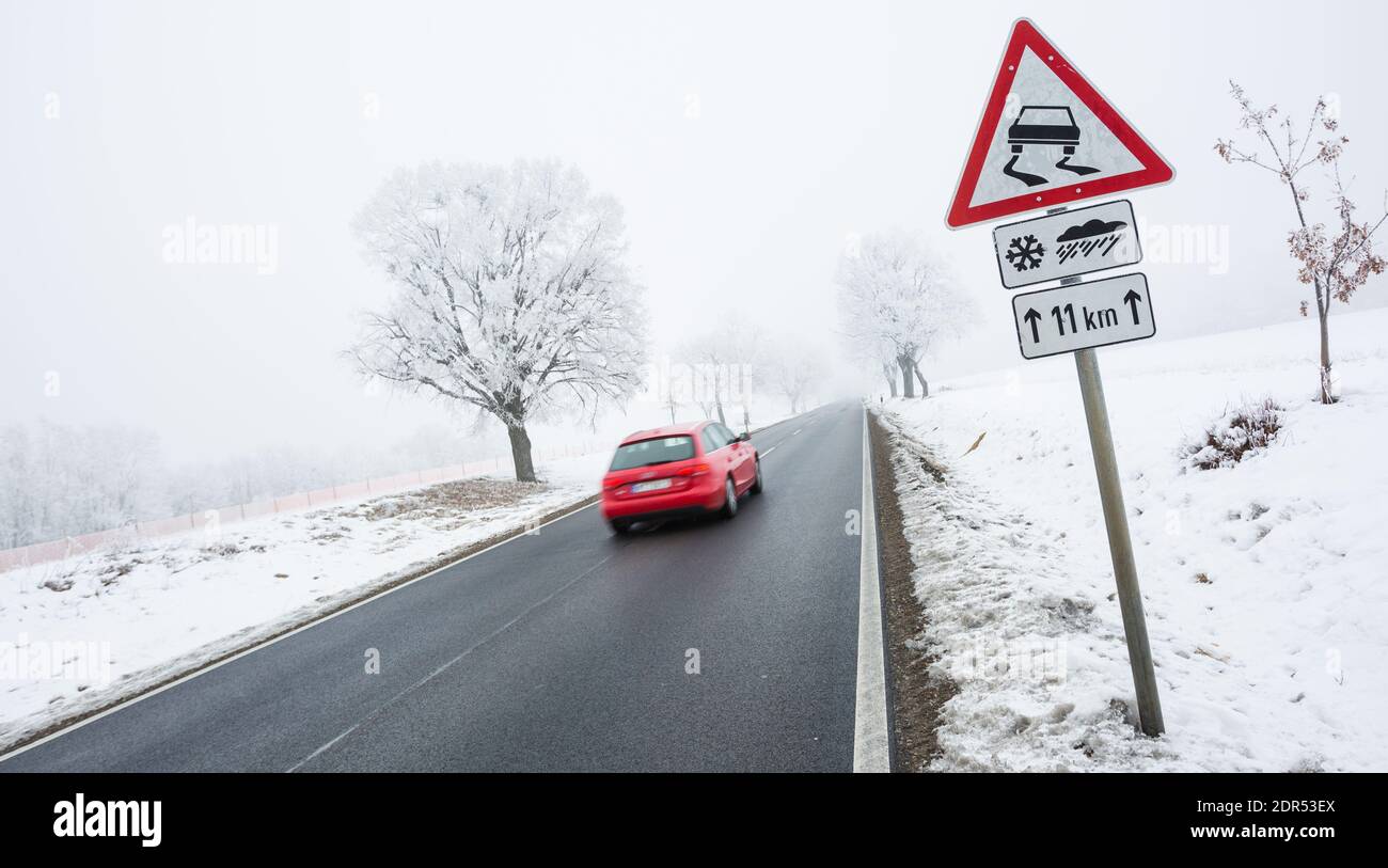 winter warning sign with snow Stock Photo - Alamy