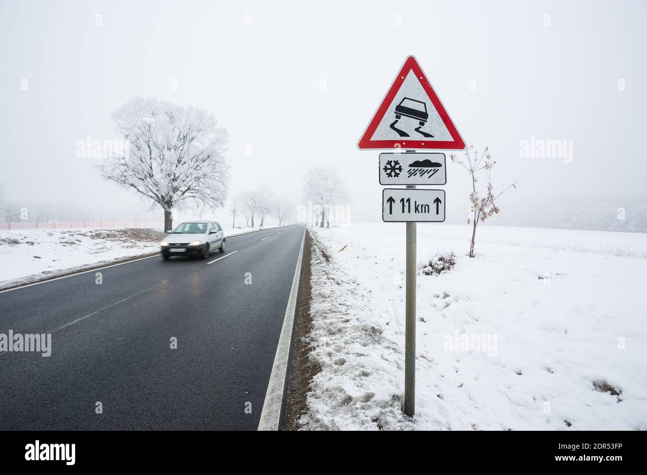 winter warning sign with snow Stock Photo - Alamy
