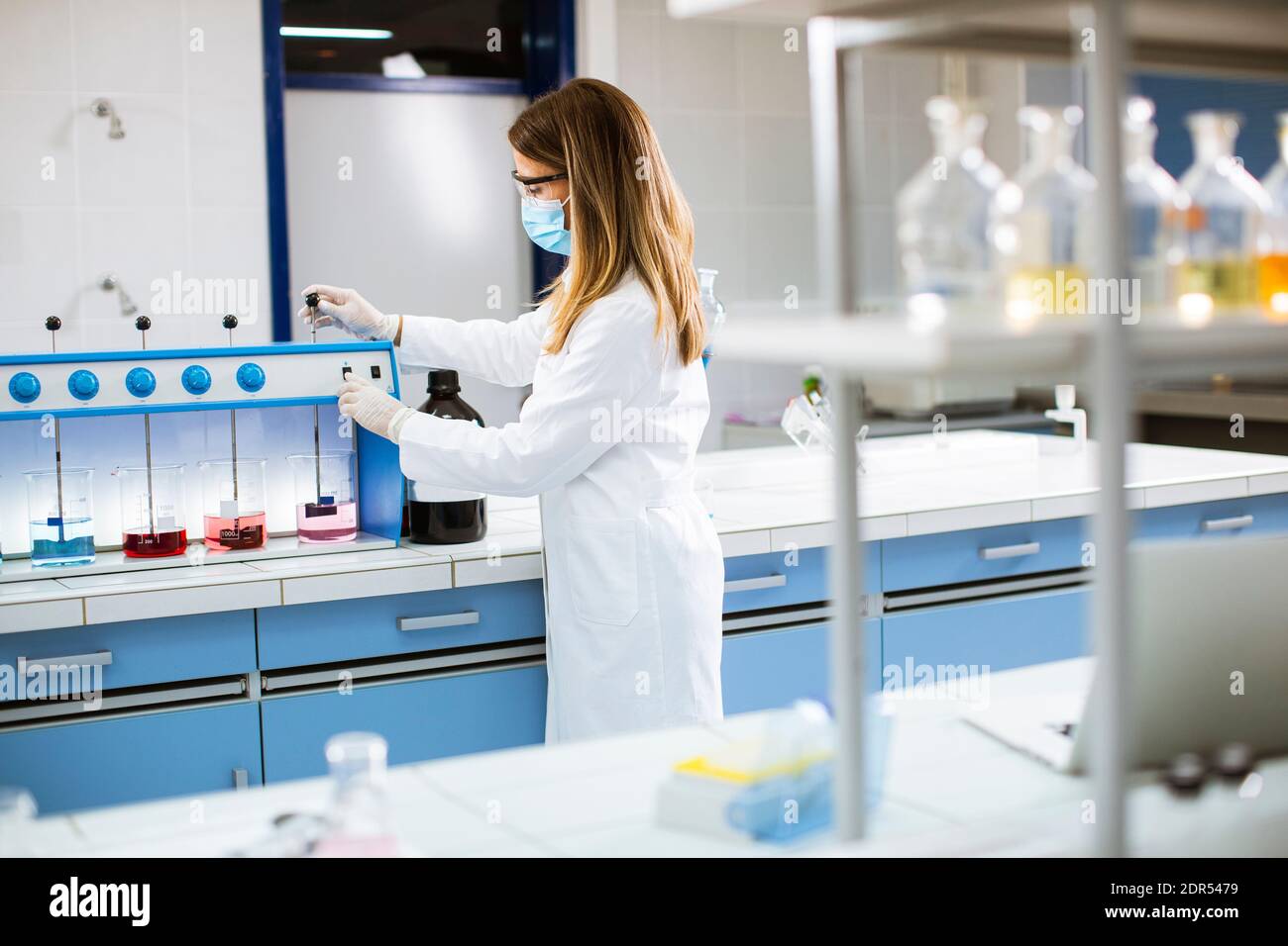 Young female researcher analyzing chemical data in the flocculator at ...
