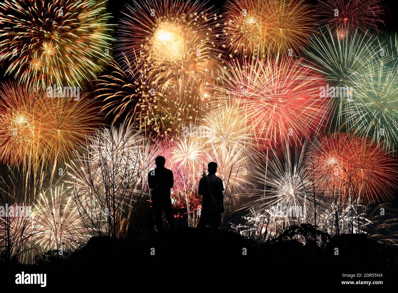 Friend standing on the hill and watching the fireworks Stock Photo - Alamy