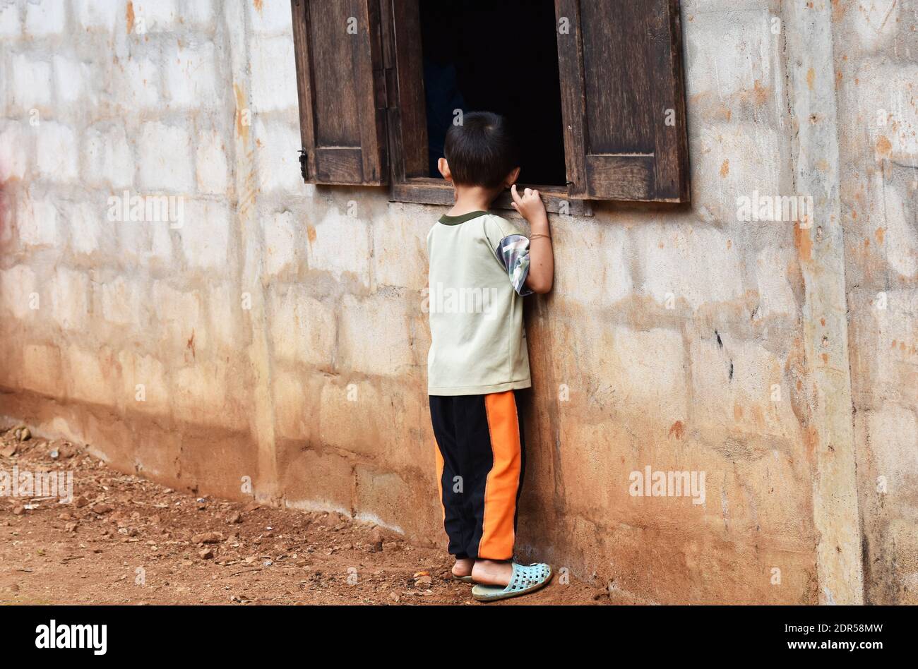 Boy Standing Behind Wall High Resolution Stock Photography and Images ...