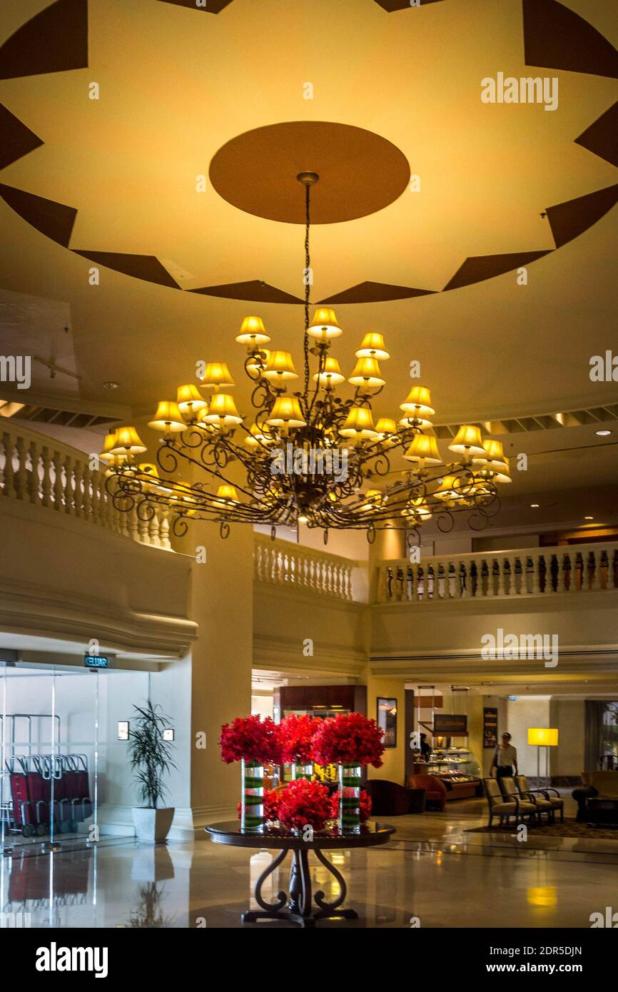 the interior design of a beatiful lobby with red flowers and a big ...