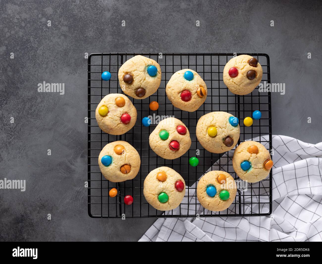 freshly baked homemade cookies with multi-colored candy on dark ...
