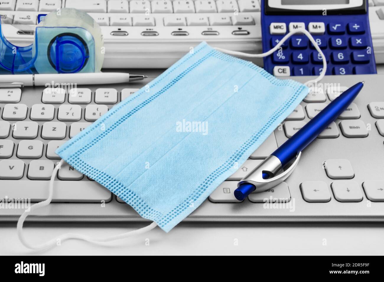 Face Mask in office with PC keyboard Stock Photo - Alamy