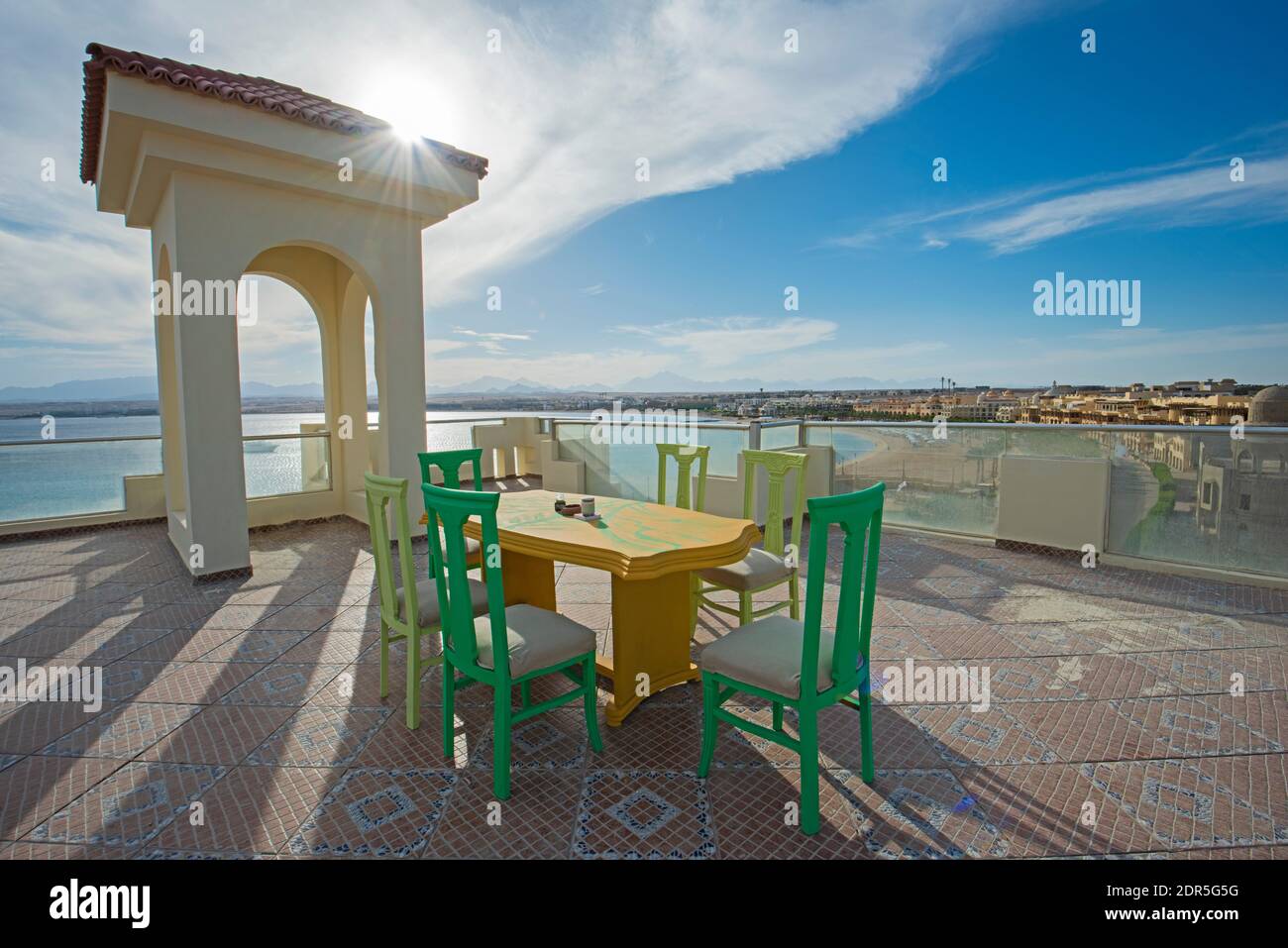 Chairs and table in rooftop dining area at a luxury tropical hotel ...