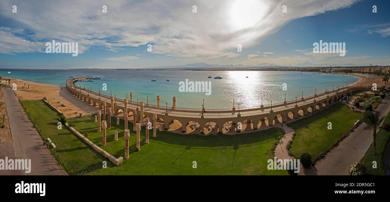 Aerial panoramic view across a beautiful landscaped garden to the sea ...