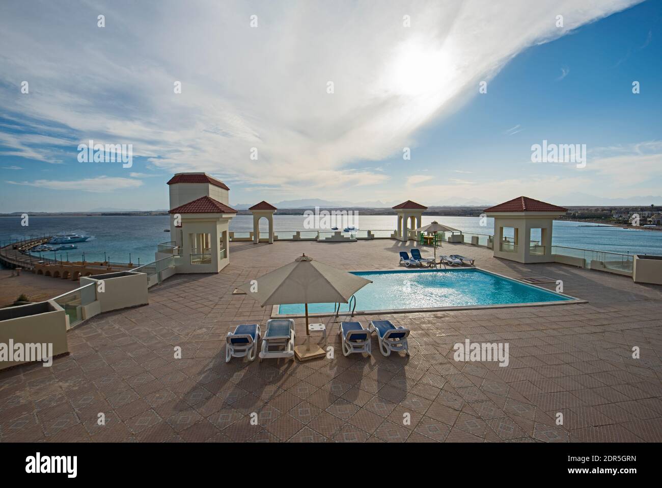 Large rooftop swimming pool with sea view at a luxury tropical hotel ...