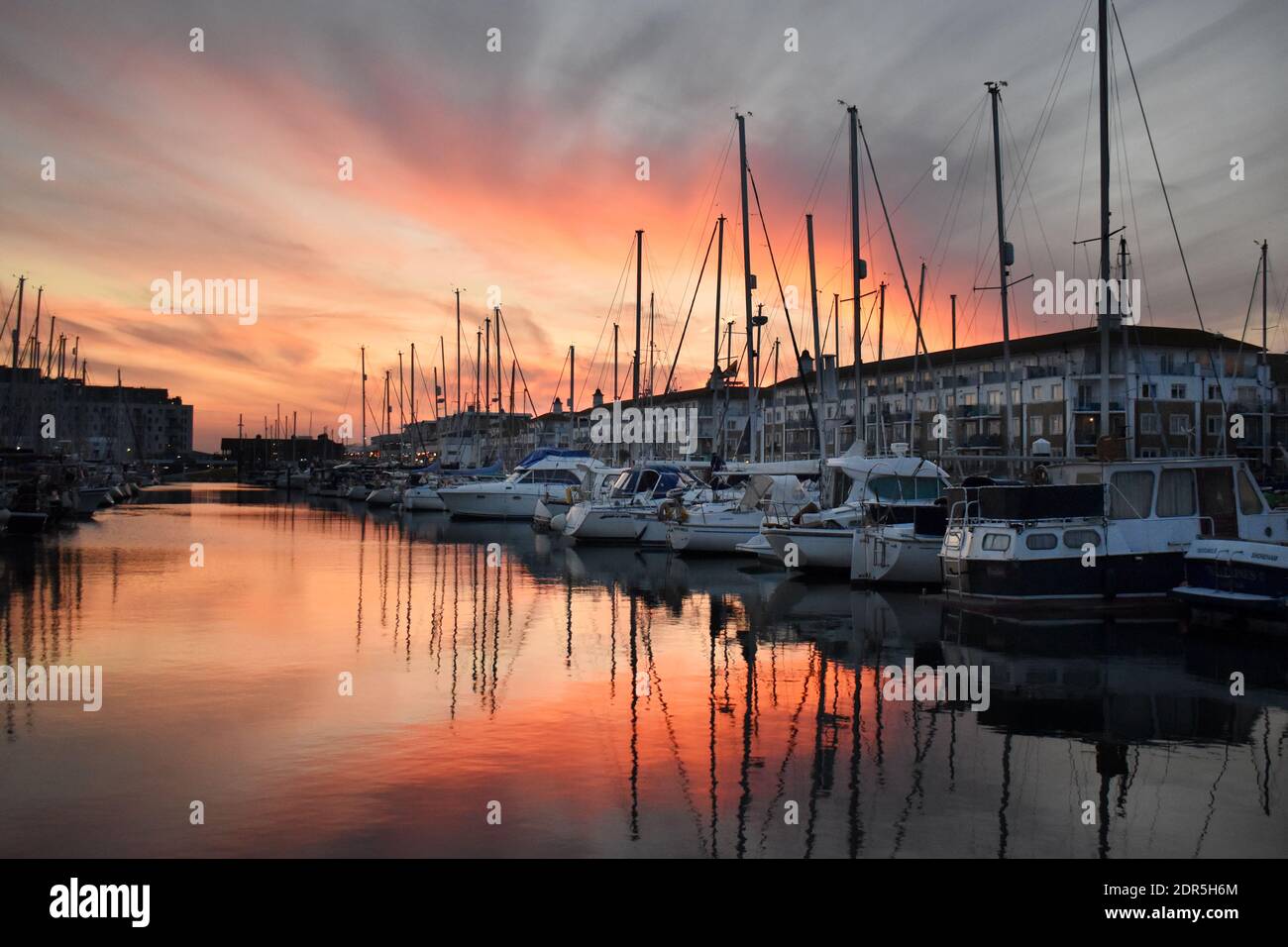 Sunset on Brighton Marina with reflection of sky in the water Stock ...
