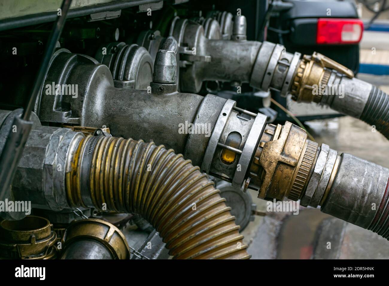 Unloading of fuels, spouts of a fuel tanker unloading at a service ...
