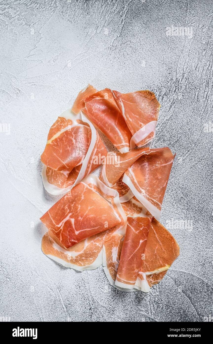 Italian prosciutto crudo, cured ham. White background. Top view Stock ...