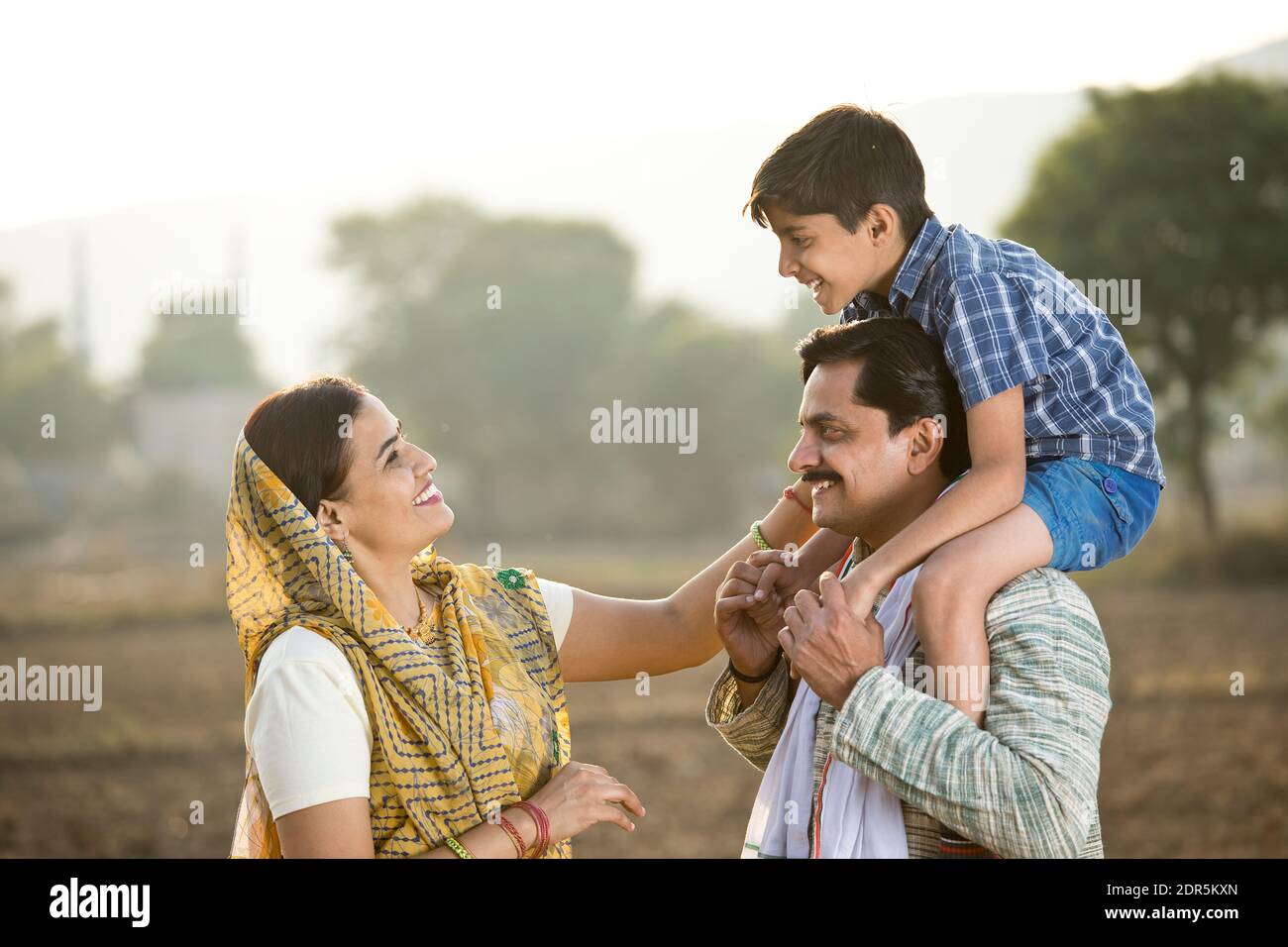 Happy rural Indian family on agricultural field Stock Photo - Alamy