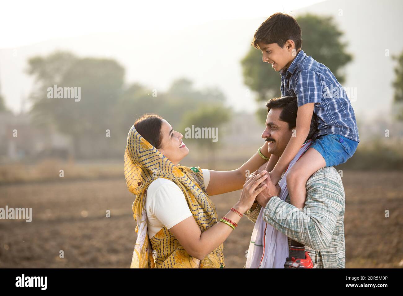 Happy rural Indian family on agricultural field Stock Photo - Alamy