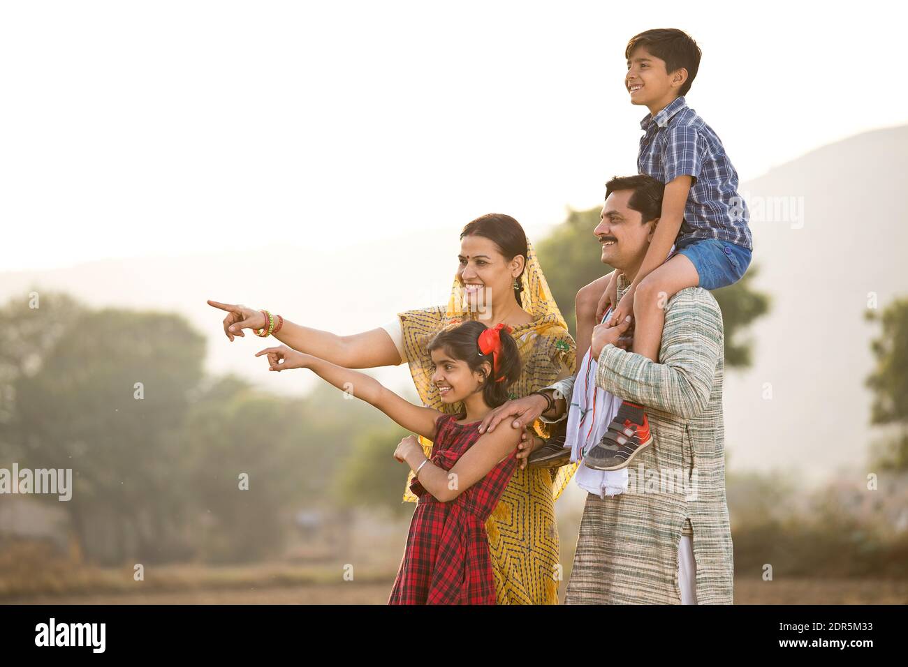 Happy rural Indian family on agricultural field Stock Photo - Alamy