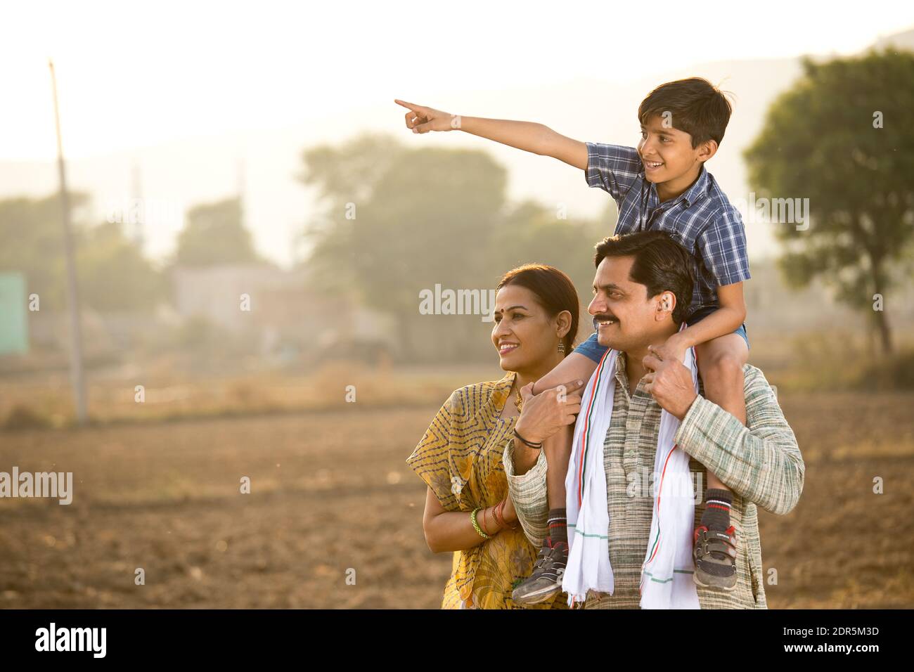Happy rural Indian family on agricultural field Stock Photo - Alamy