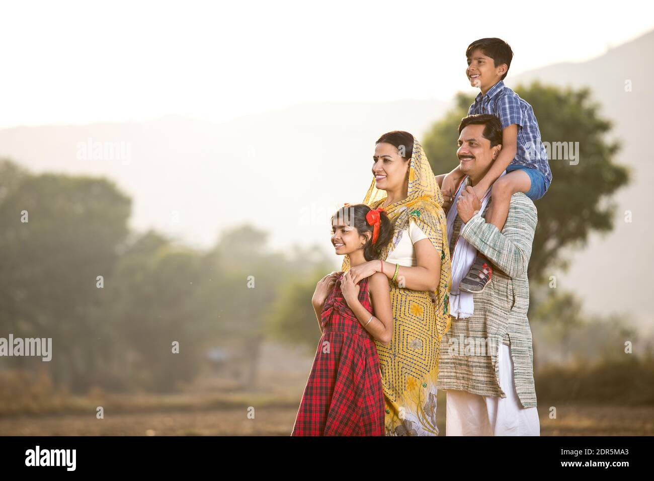 Happy rural Indian family on agricultural field Stock Photo - Alamy