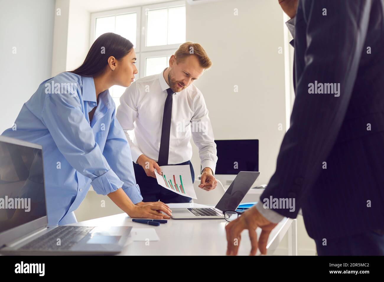 Professional male manager shows infographics to his colleagues during a ...