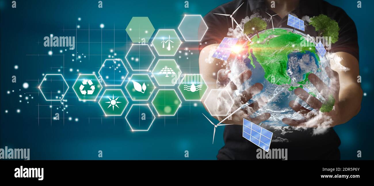 Man holding planet Earth with solar panels, fans and renewable energy ...