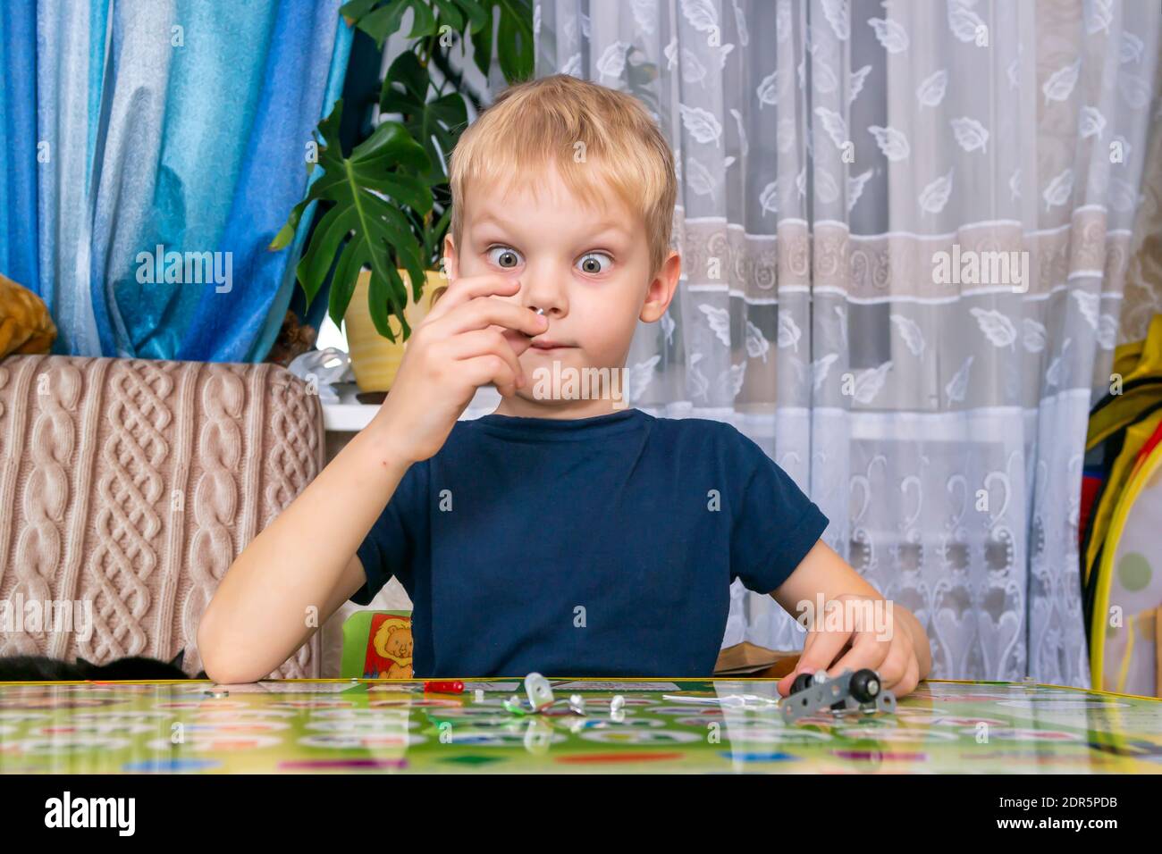 the boy looks at the extra detail from the children's designer with ...