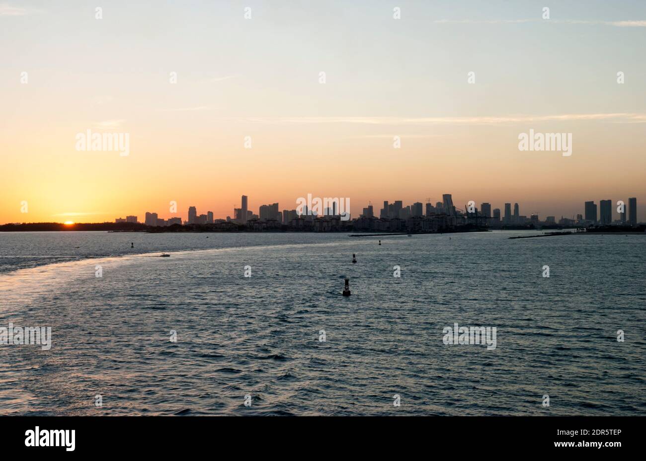 The view of Miami downtown skyline with the Sun going down behind the ...