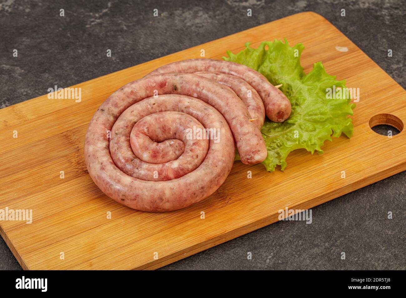 Raw pork sausage ring for grill Stock Photo - Alamy