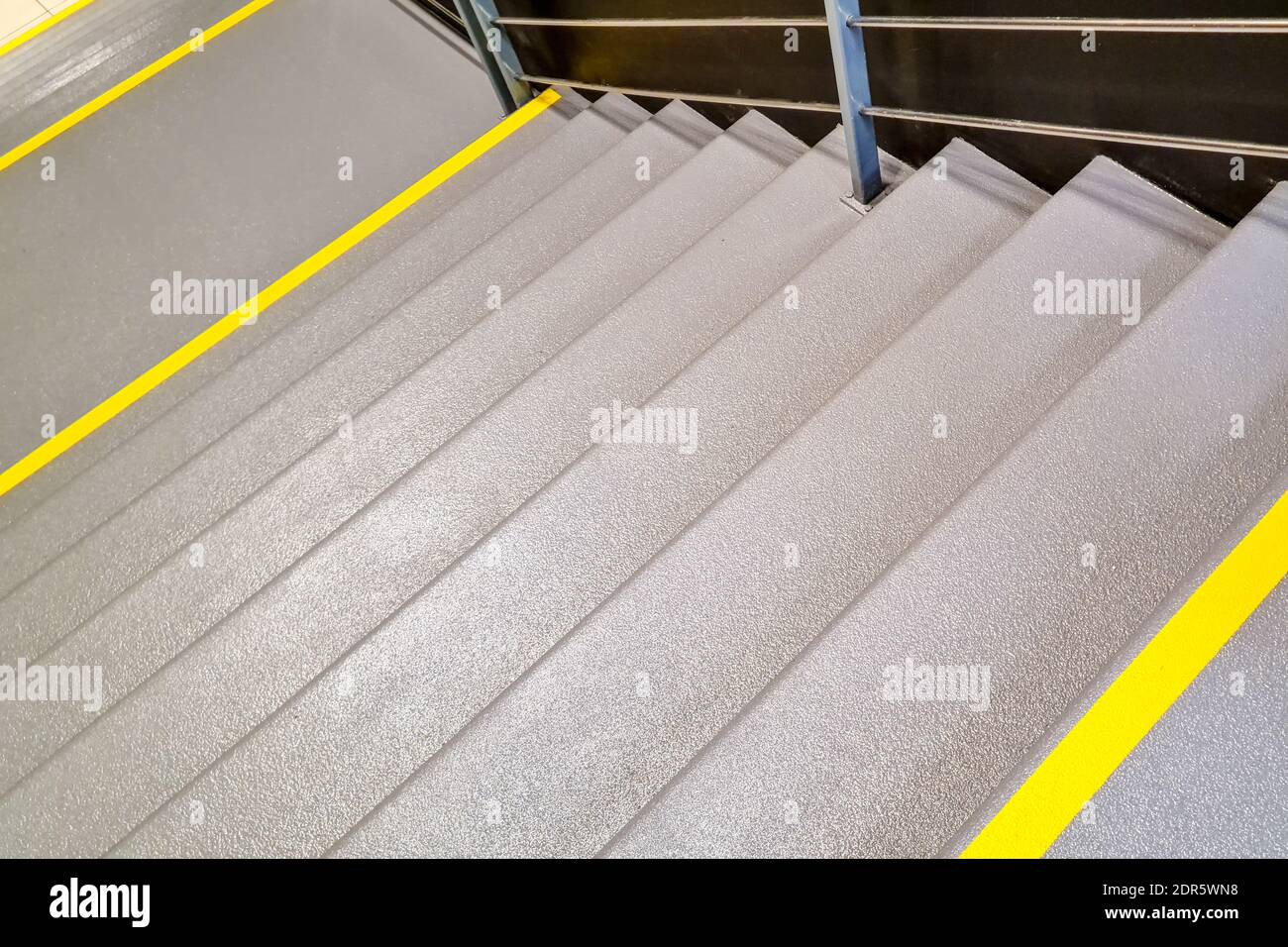 yellow warning sign on stairs signifying a potential hazard, steep ...