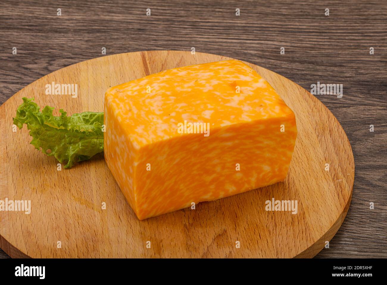 Dairy Marble cheese brick over board Stock Photo - Alamy