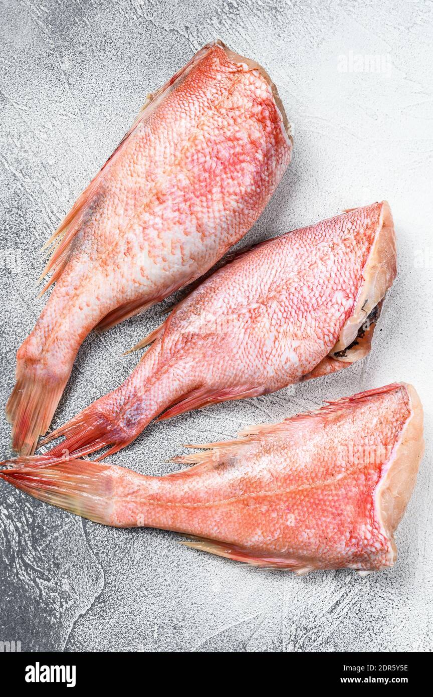 Raw Red perch or seabass fish. White background. Top view Stock Photo ...
