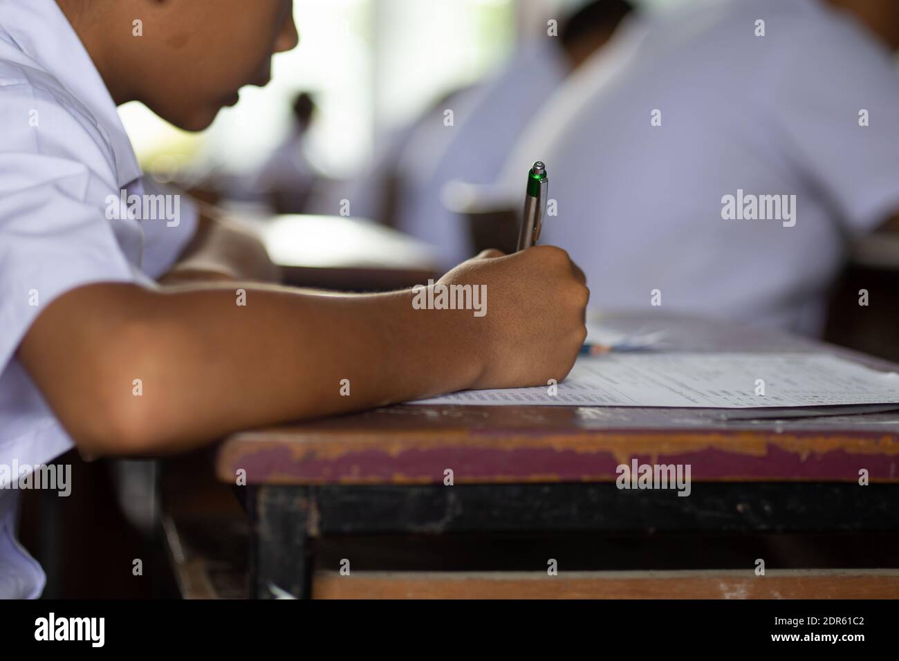 Students taking exam with stress in school classroom Stock Photo - Alamy