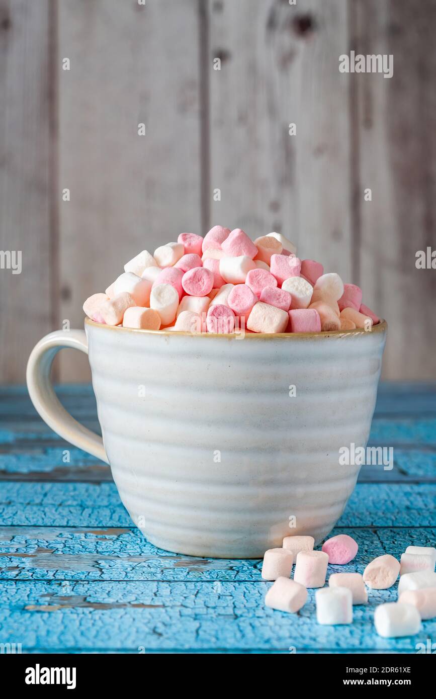 Colorful mini marshmallows in a cup on a table Stock Photo - Alamy