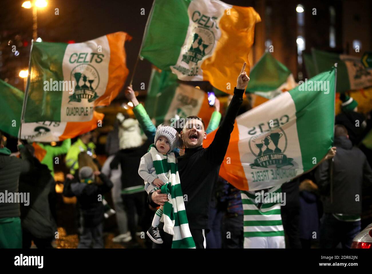 Celtic fans waving quadruple treble flags wait for the team bus to ...