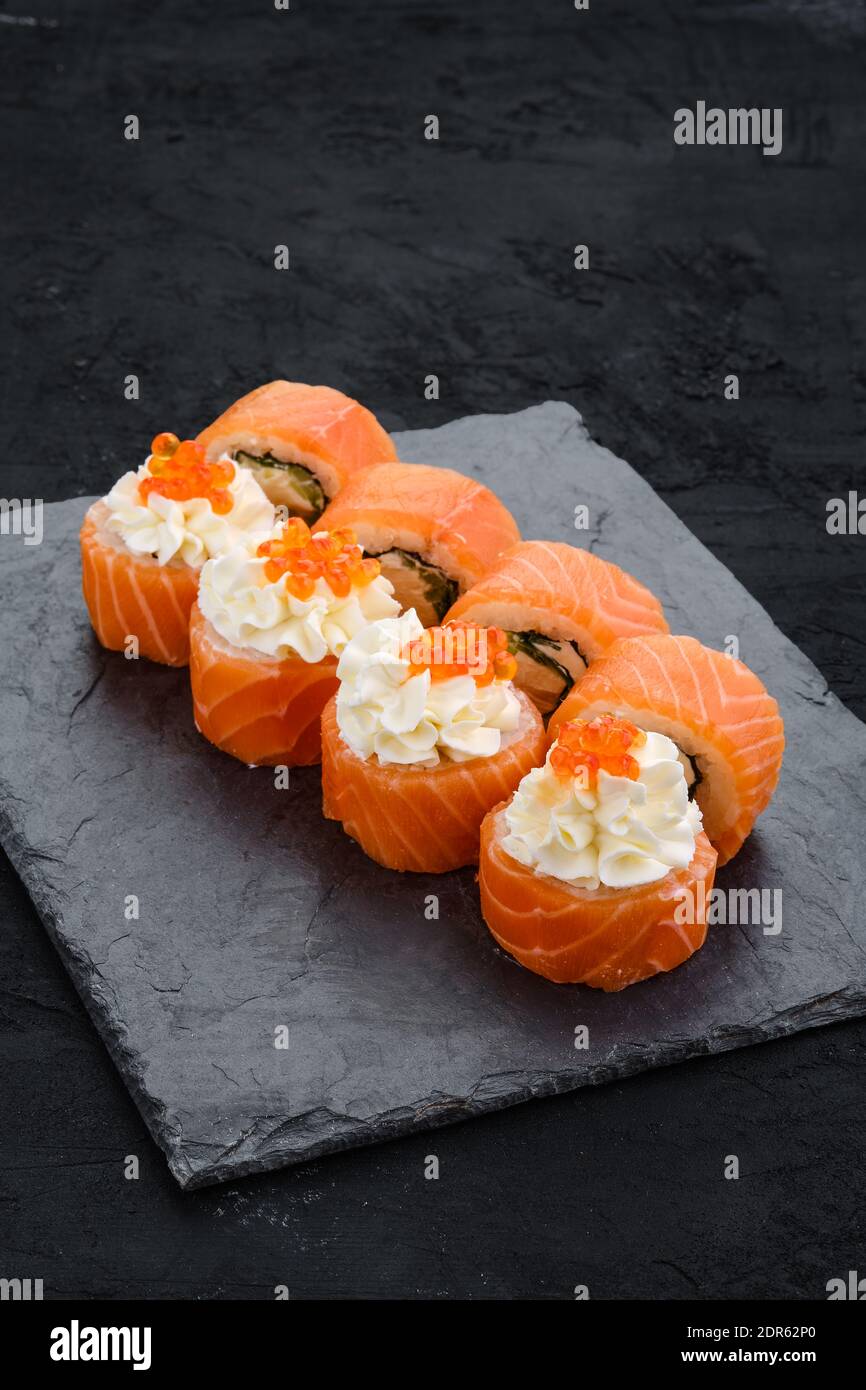 Rolls with salmon and cream cheese with caviar Stock Photo - Alamy