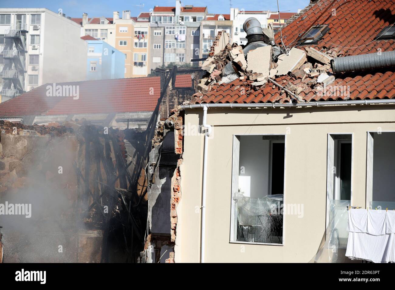 Lisbon, Portugal. 20th Dec, 2020. Smoke rises from a destroyed building ...