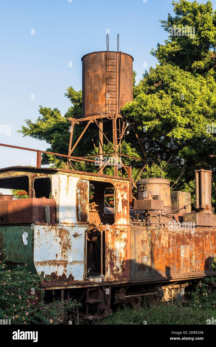 Old rusty abandoned train and rusty elevated water tank in the old ...