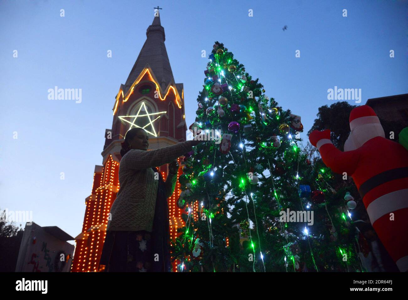 Pakistani christian woman is busy in decorating the St. Anthony's ...