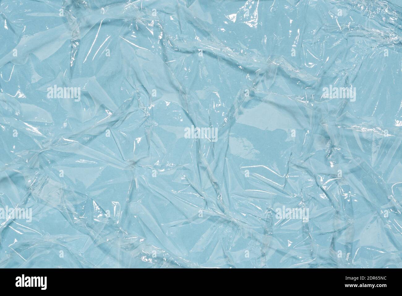 Wrinkled cling film, blue vinyl background. Abstract, art design, wet ...