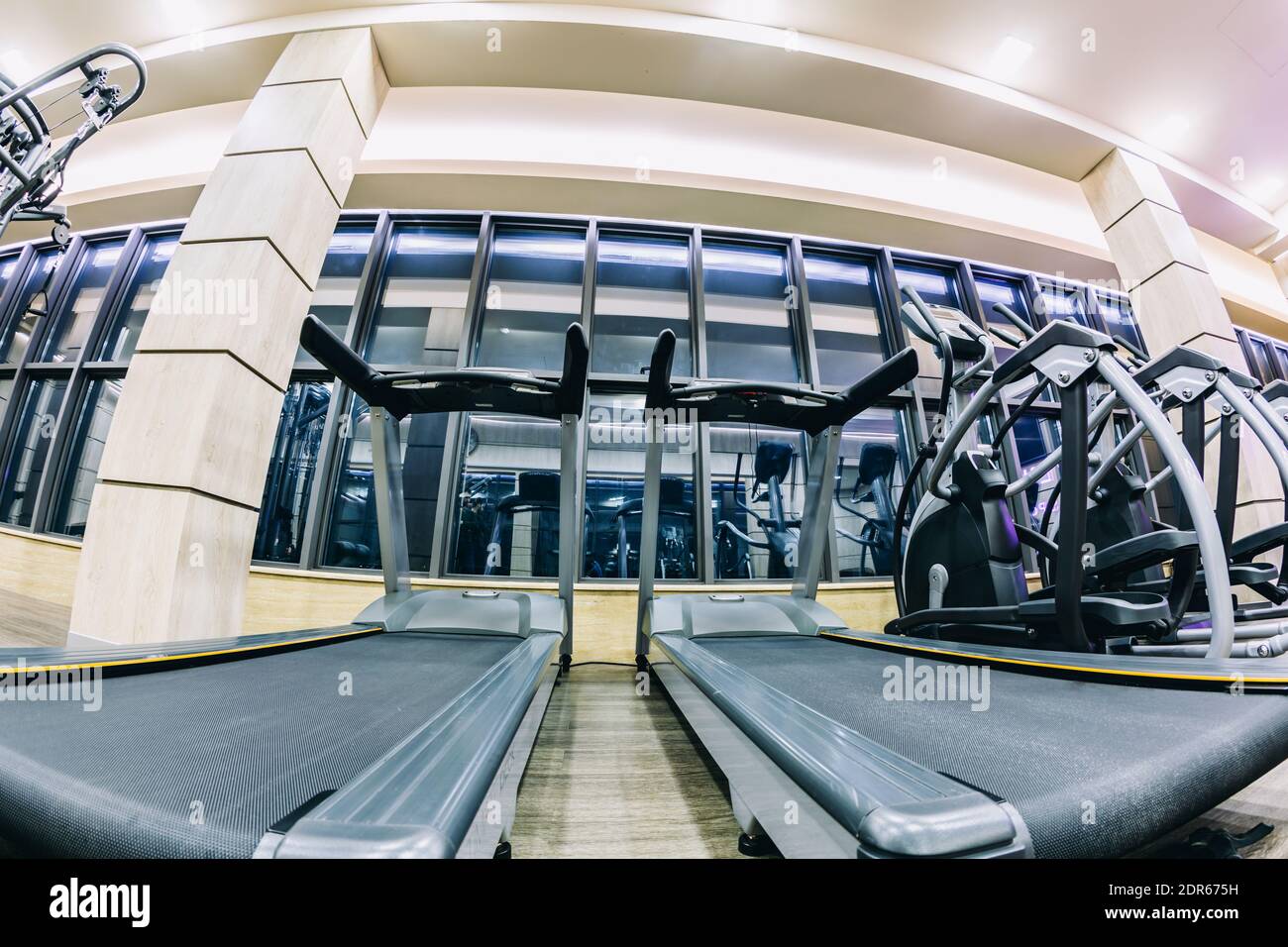 Professional treadmills in sport complex in front of windows Stock ...