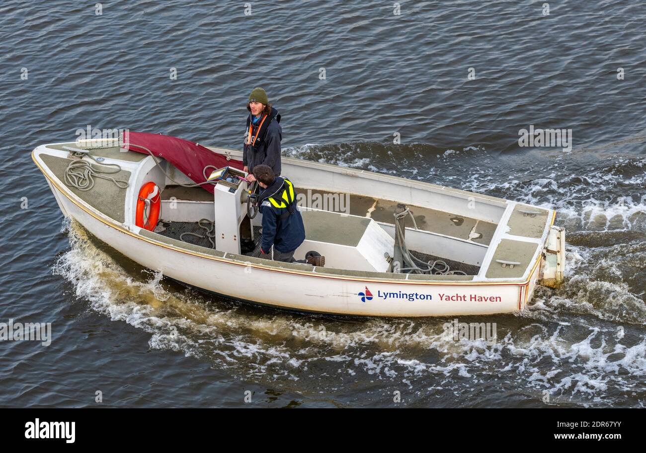 lymington yacht haven mooring launch with two crew Stock Photo - Alamy