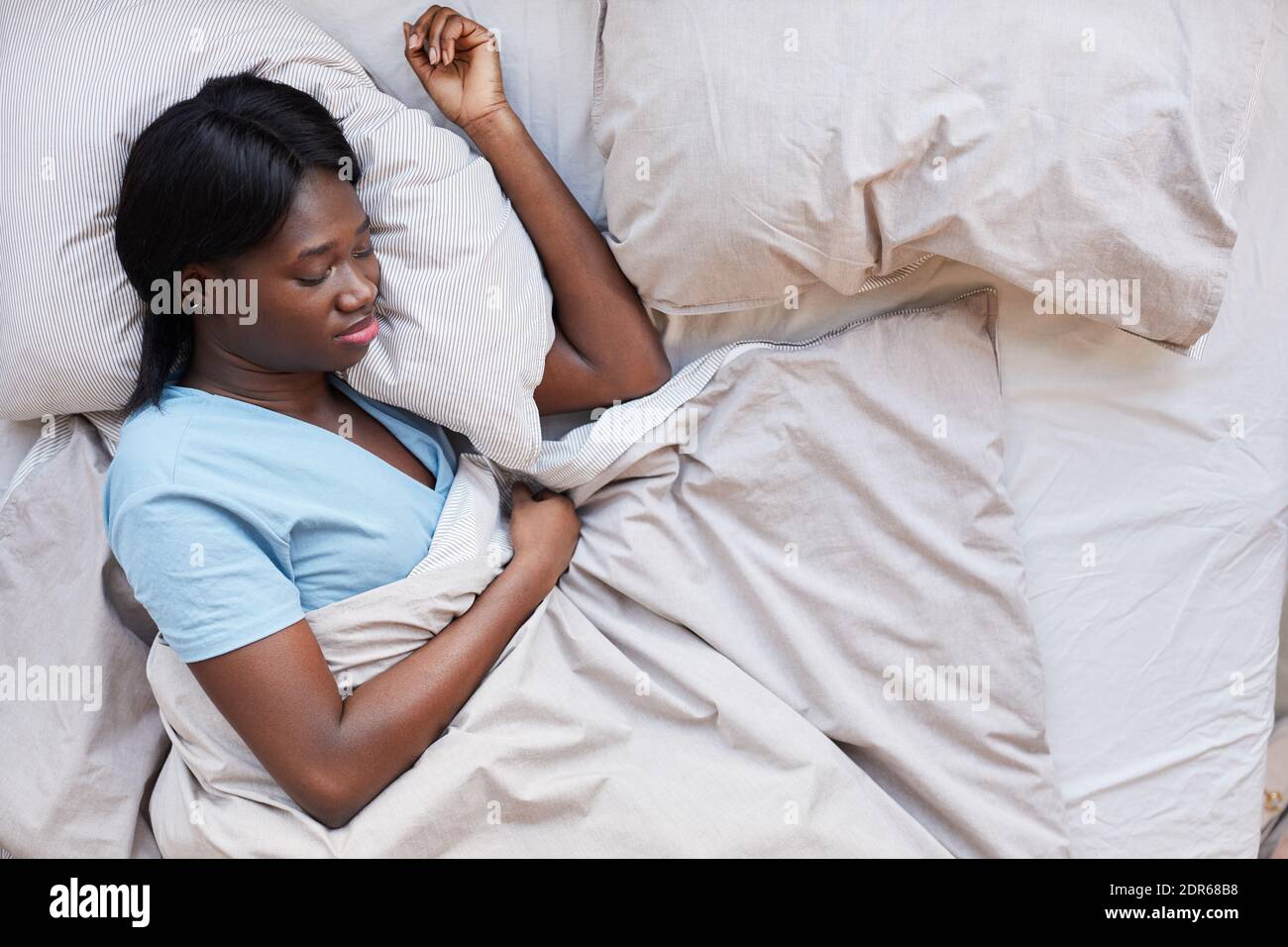 Minimal top view portrait of young African-American woman sleeping ...