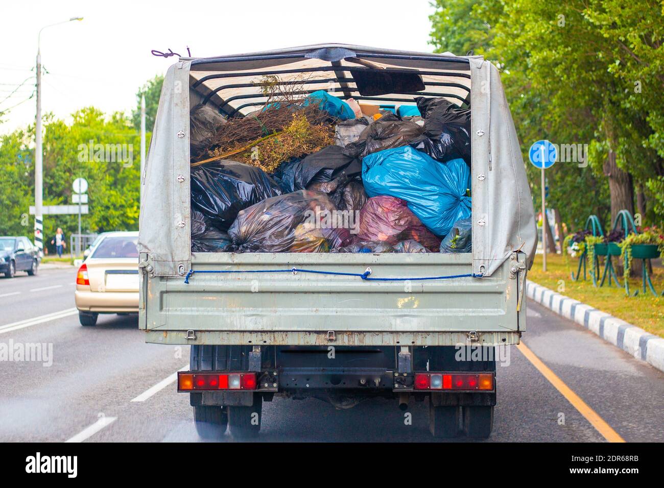 truck with garbage bags in the back. Cleaning and transportation of ...