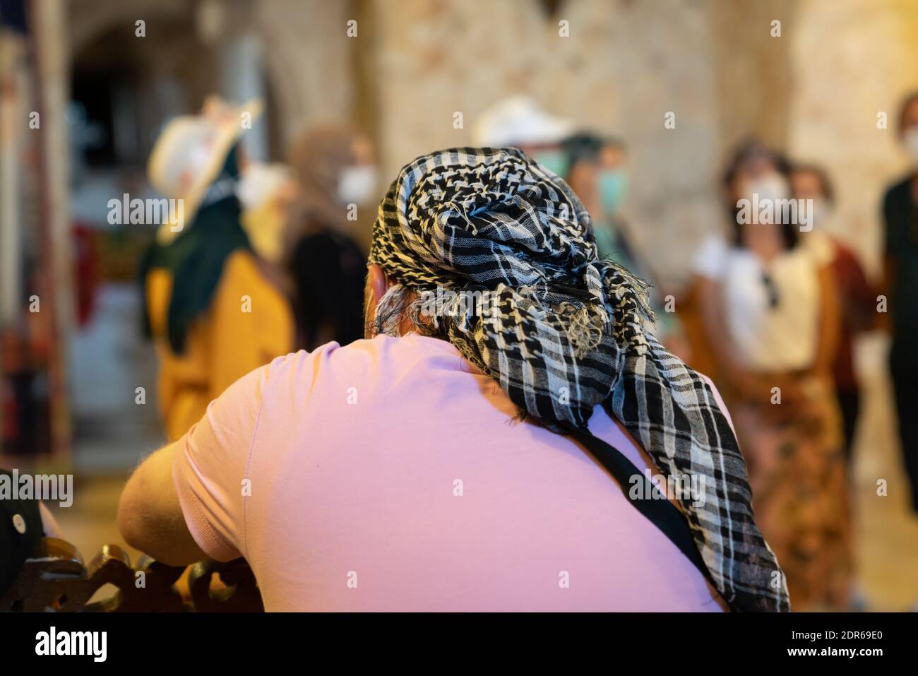 Back rear view of middle eastern man with scarf sit at the street Stock ...